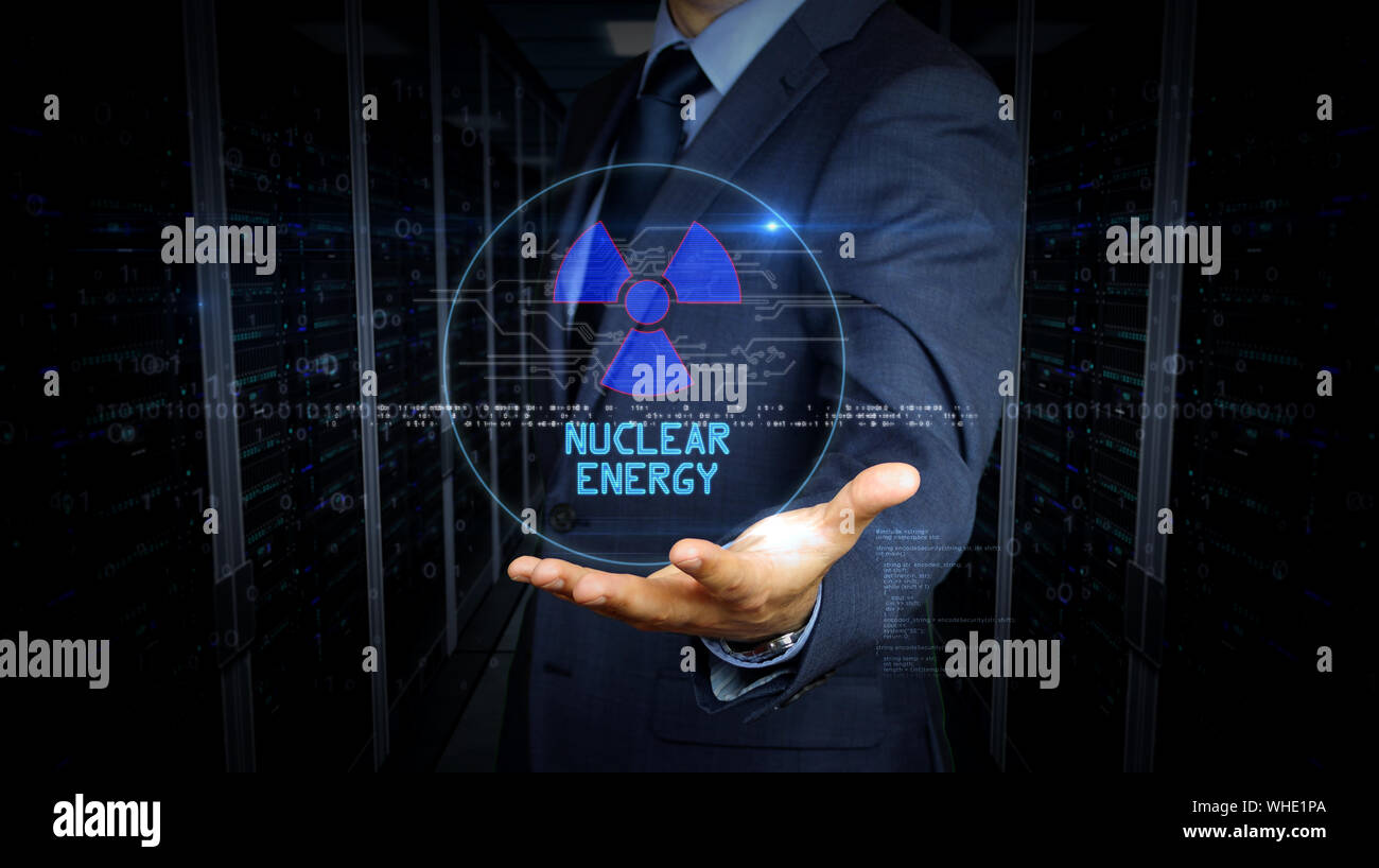 A businessman in a suit touch screen with nuclear energy symbol ...