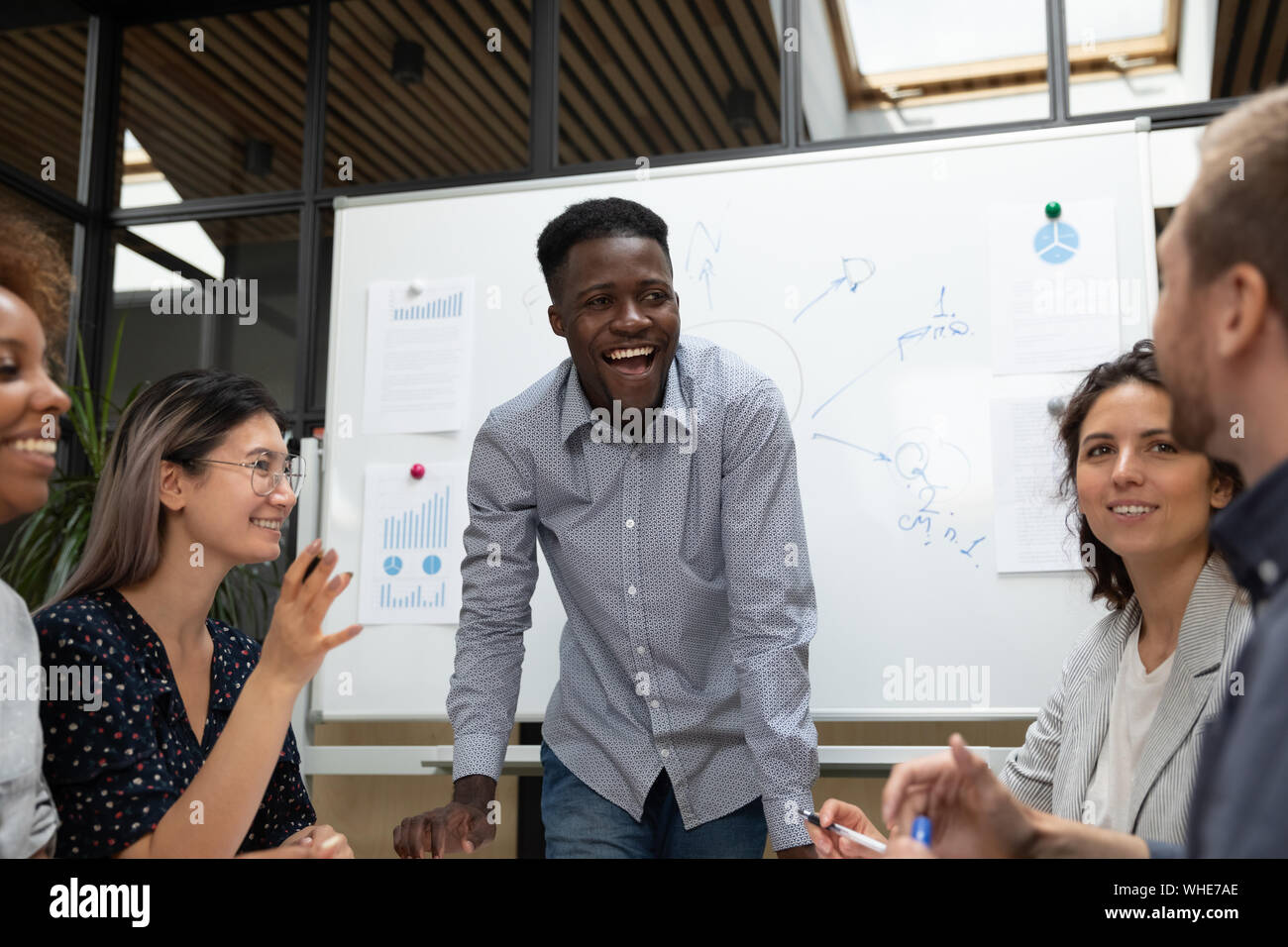 Happy male african manager and multiracial team talking at meeting ...