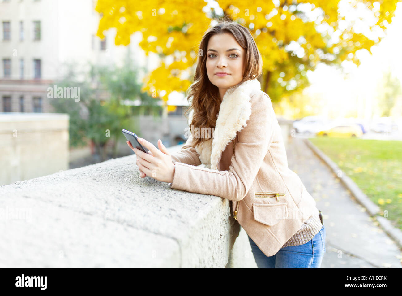 Beautiful caucasian brunette girl standing warm autumn day with ...