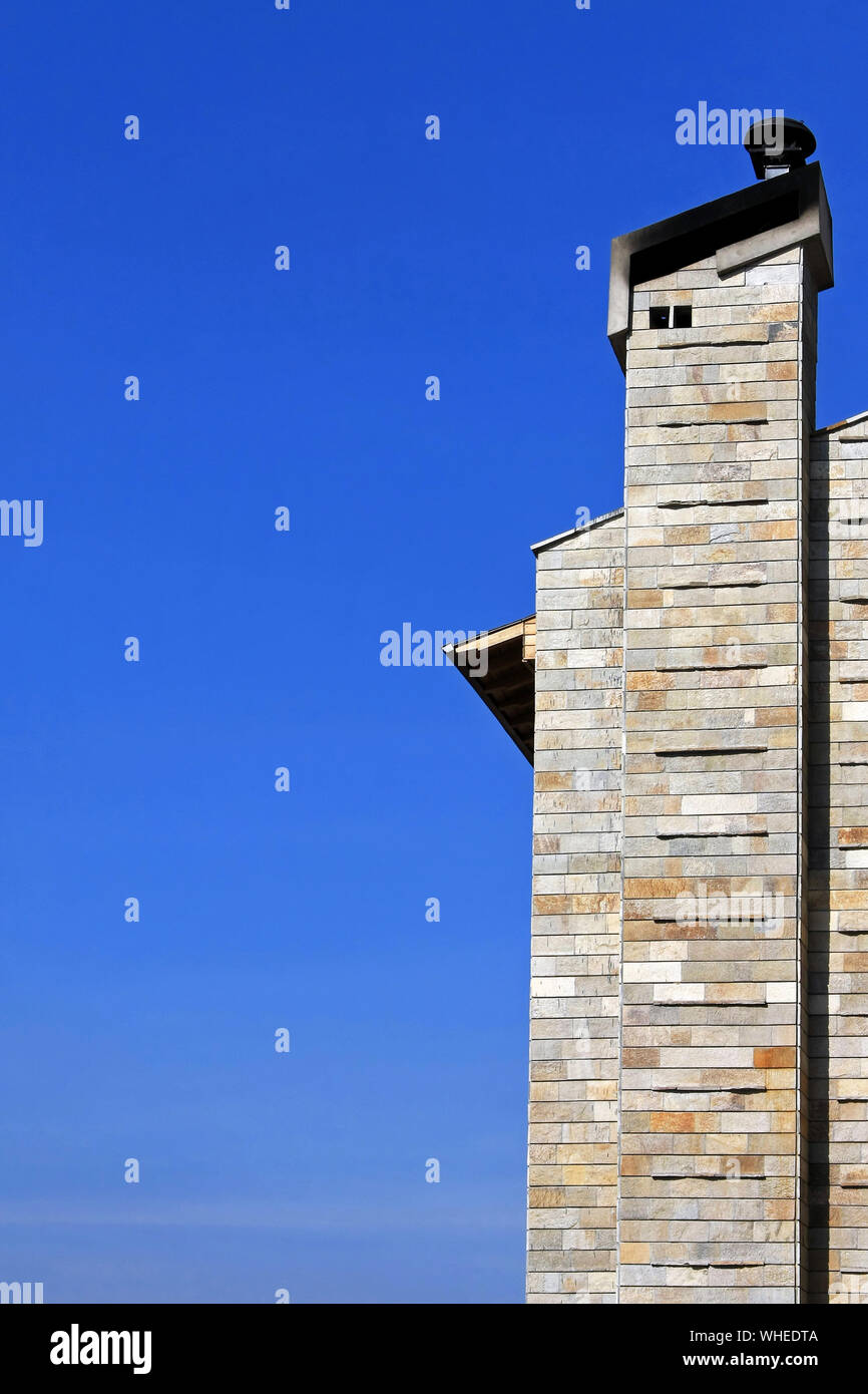 Big and tall chimney made from stone bricks Stock Photo - Alamy