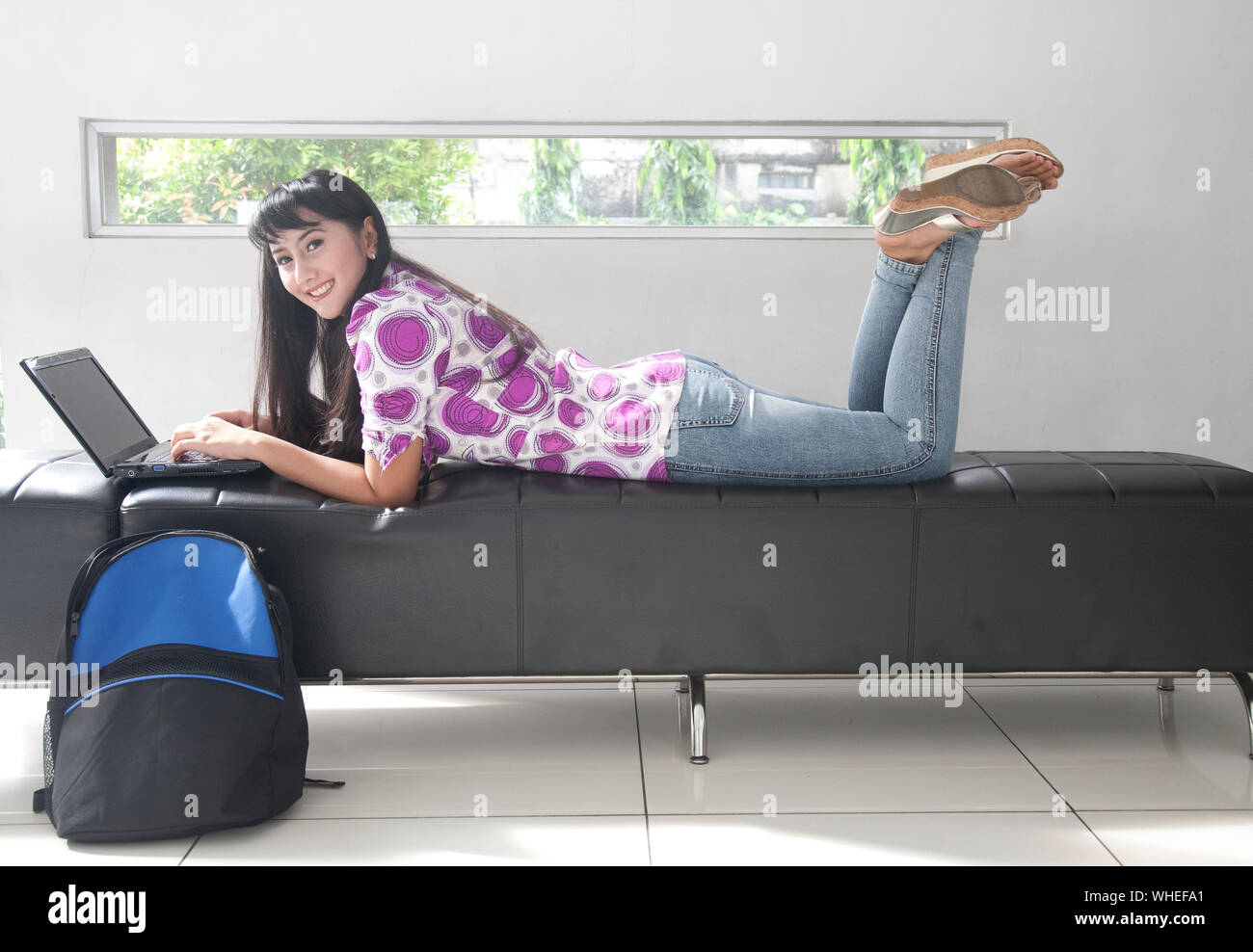 Using laptop lying down hi-res stock photography and images - Alamy