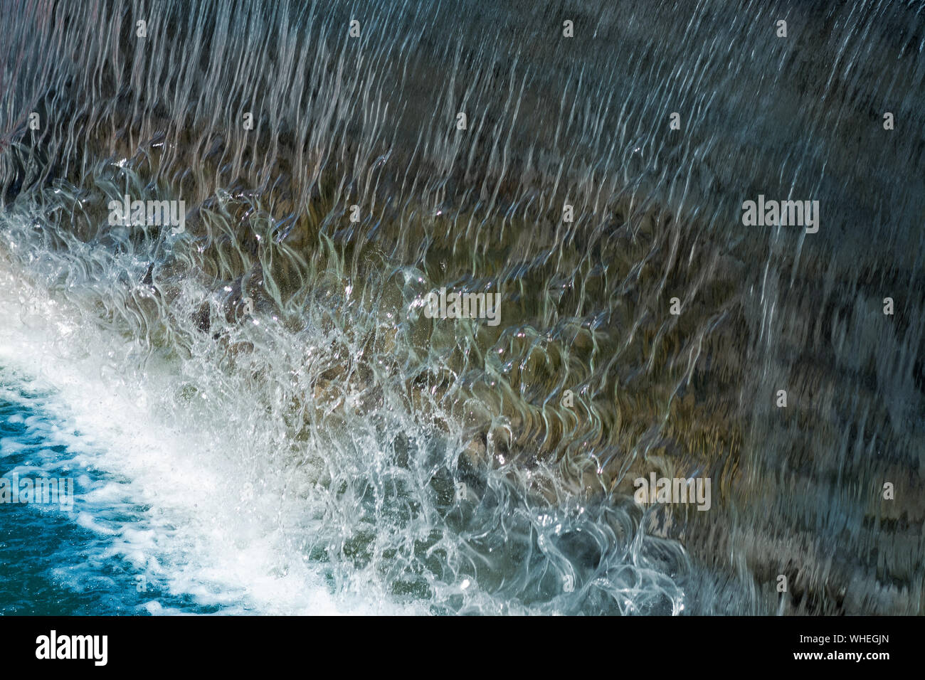 Waterfall close up image. Splashes and foam on blue water surface from ...