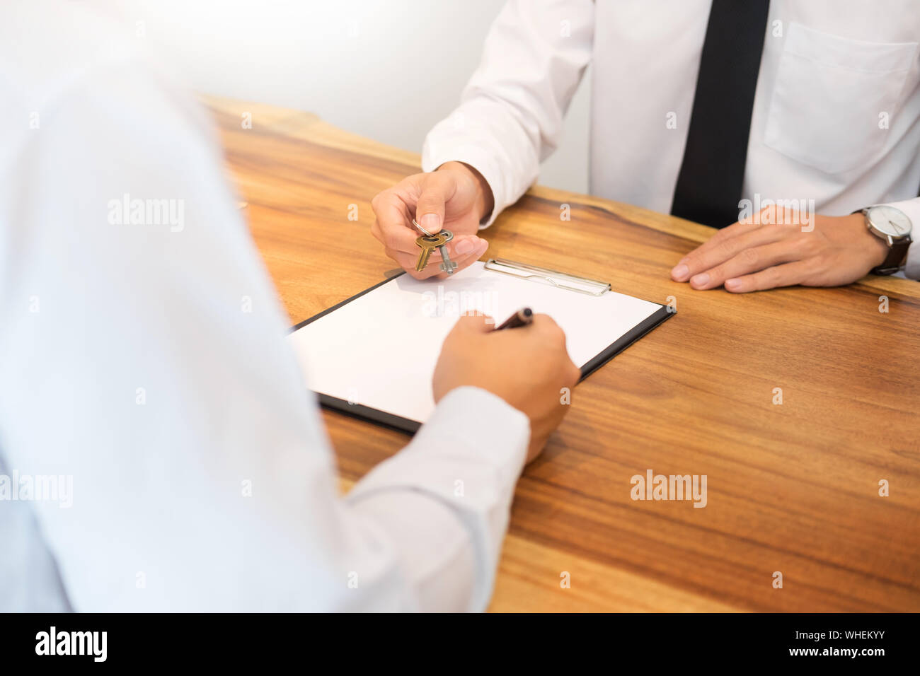 Two Business People Signing Document High Resolution Stock Photography ...