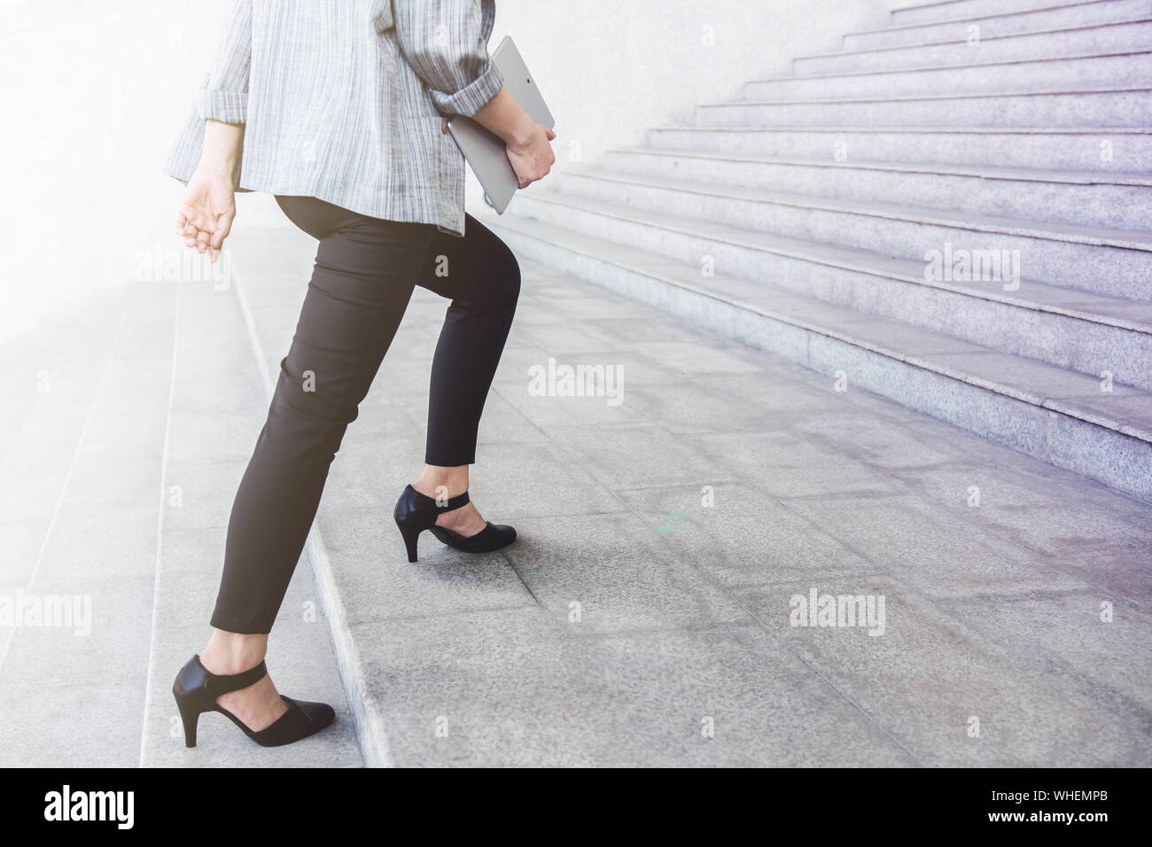 Female climbing stairs hi-res stock photography and images - Alamy