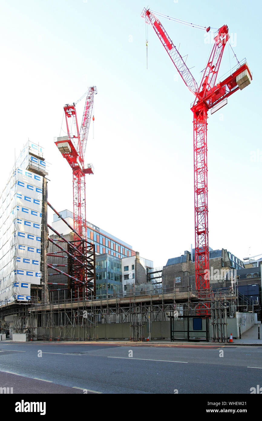 Two tall red cranes and construction site Stock Photo - Alamy