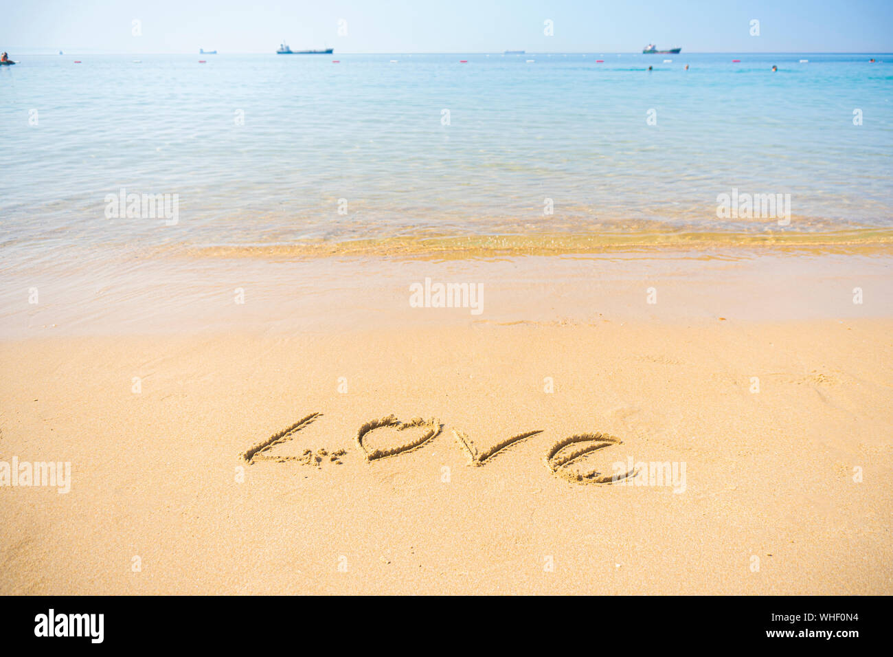 Love write on sand at beach Stock Photo - Alamy