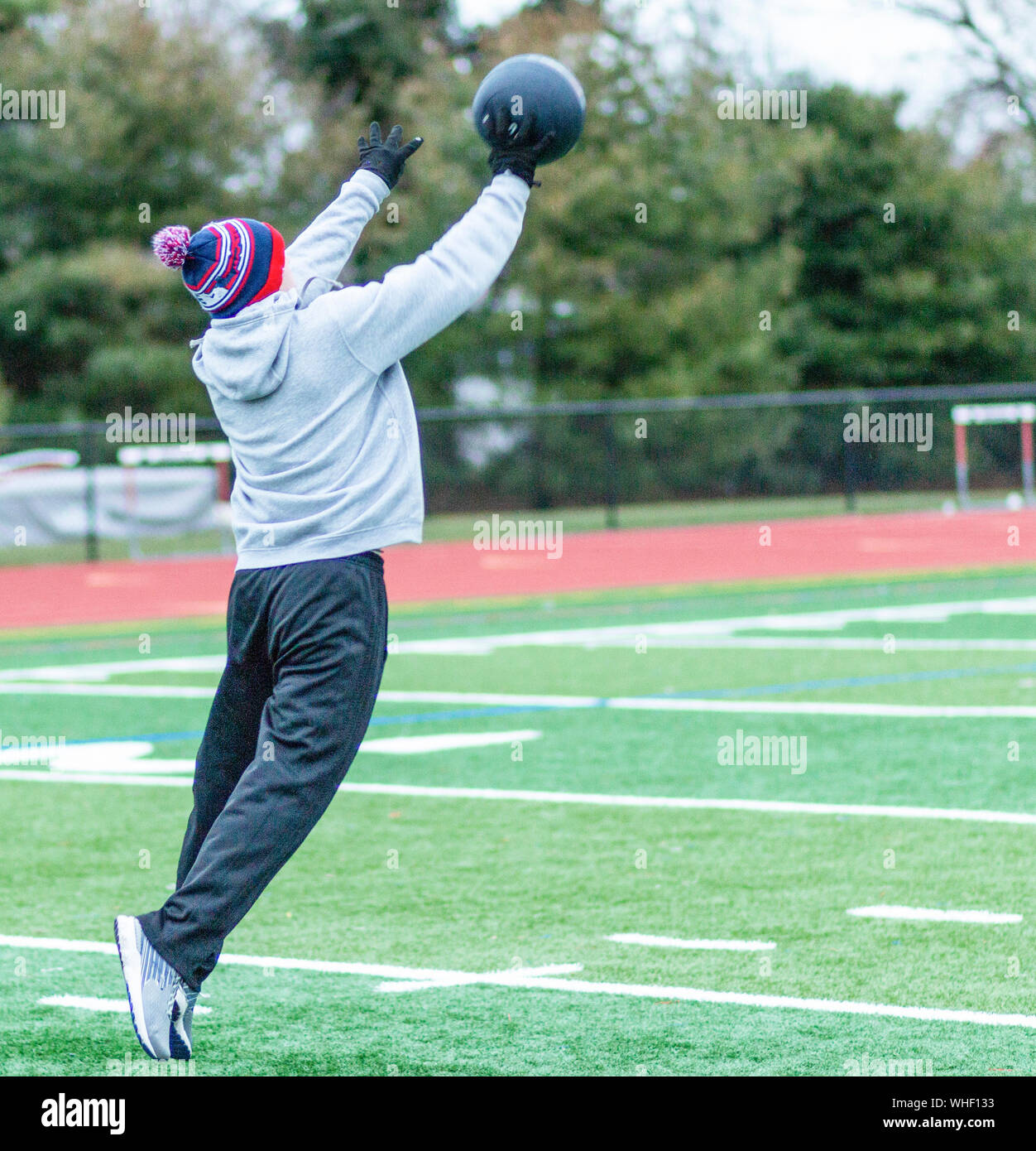 A high school track and field athlete is strength and agility training ...
