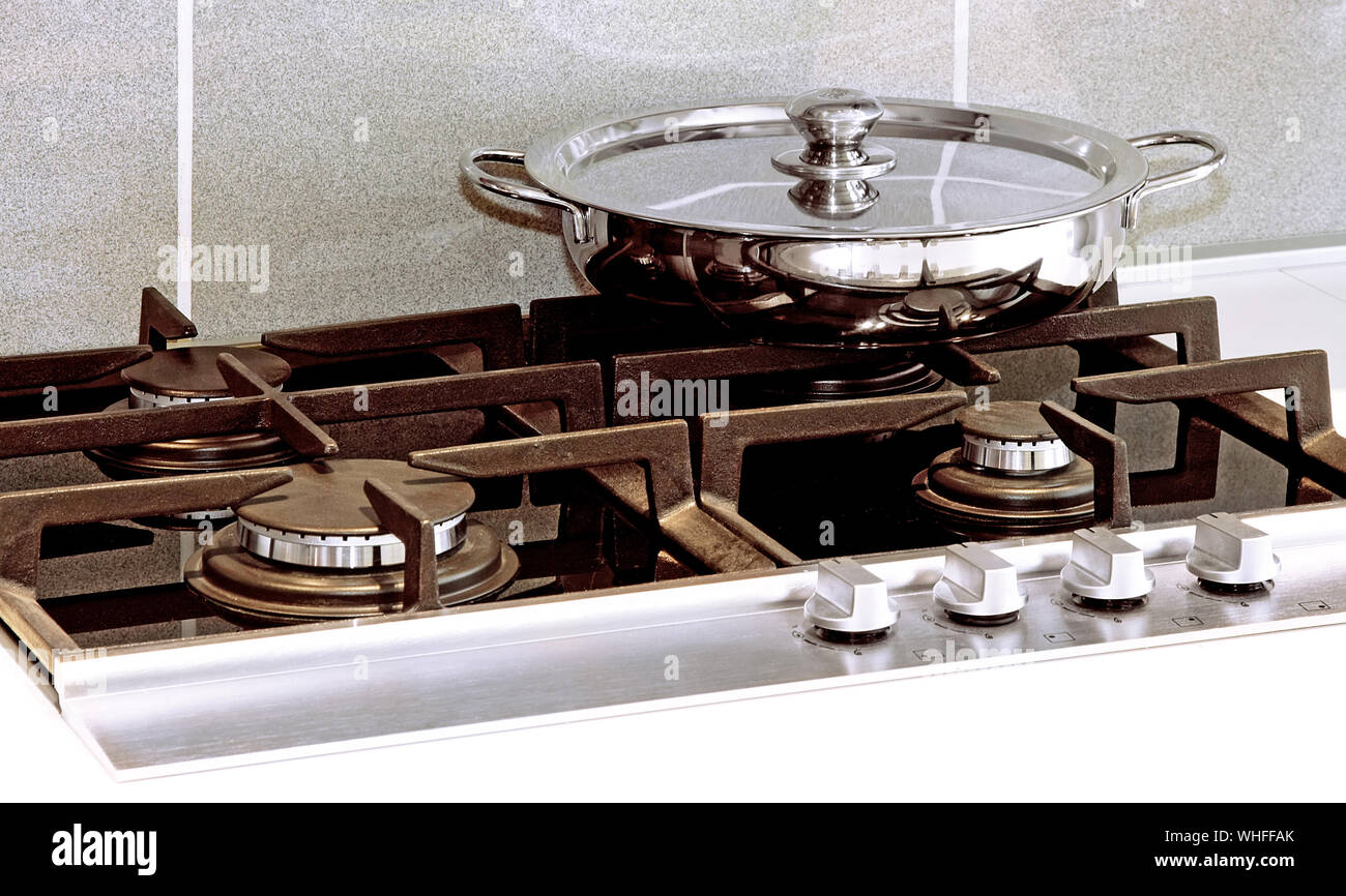 Stainless steel pan at gas stove in kitchen Stock Photo - Alamy