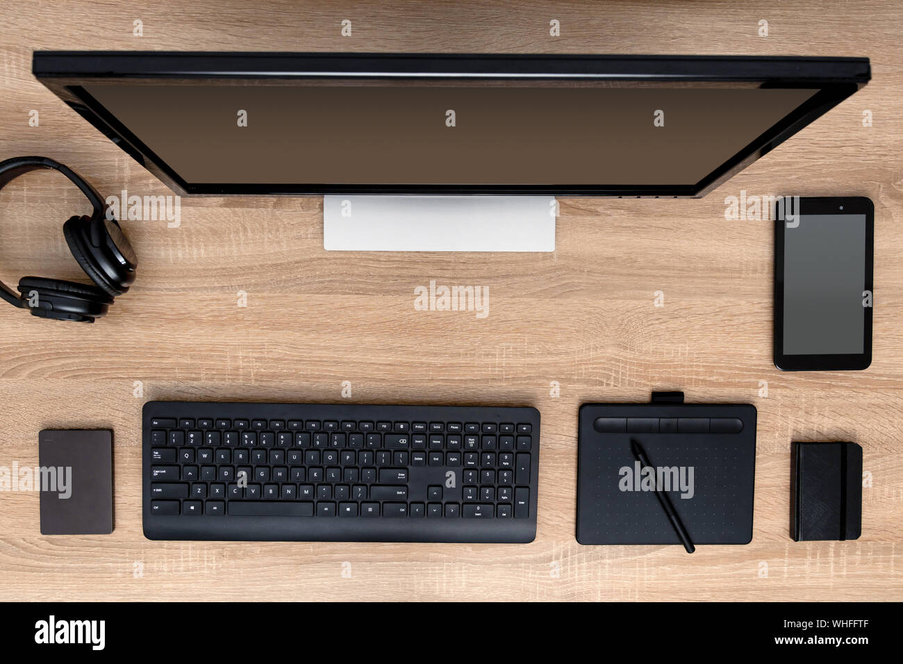 Graphic tablet with keyboard on wooden desk Stock Photo - Alamy