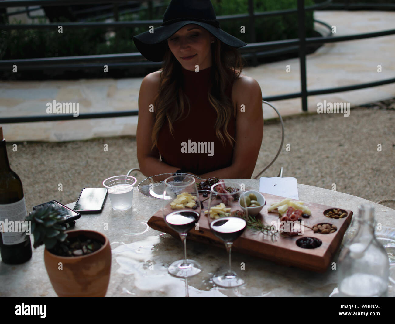 Trendy Female Model Eating Meat and Cheese Board with WIne Stock Photo ...