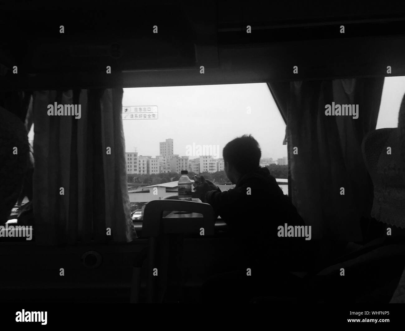 Man looking through train window Black and White Stock Photos & Images ...