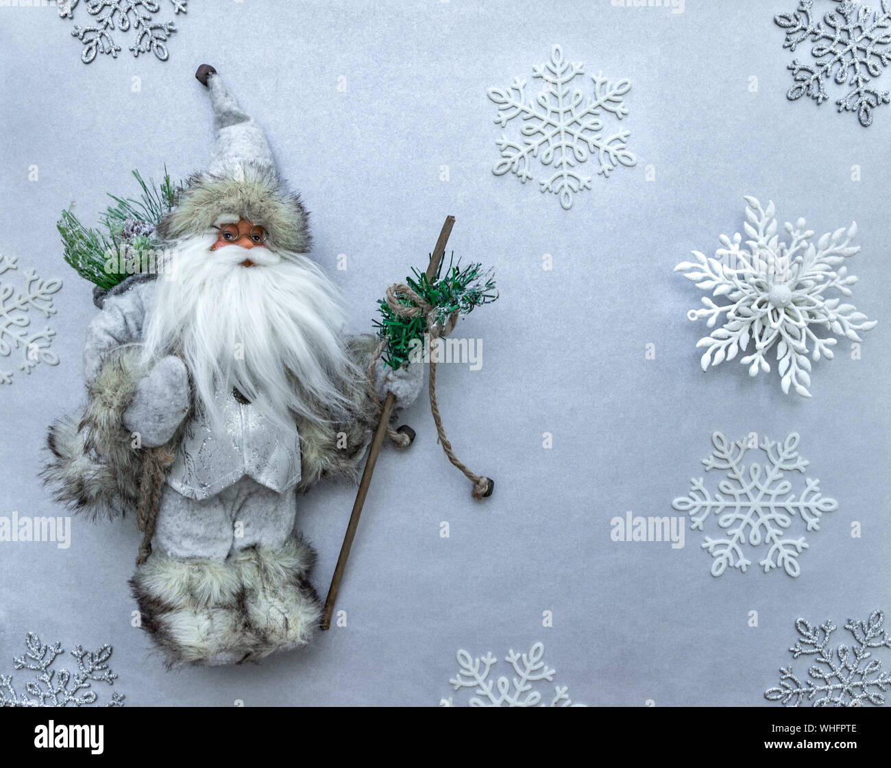 Santa figurine on silver and white Christmas background Stock Photo - Alamy