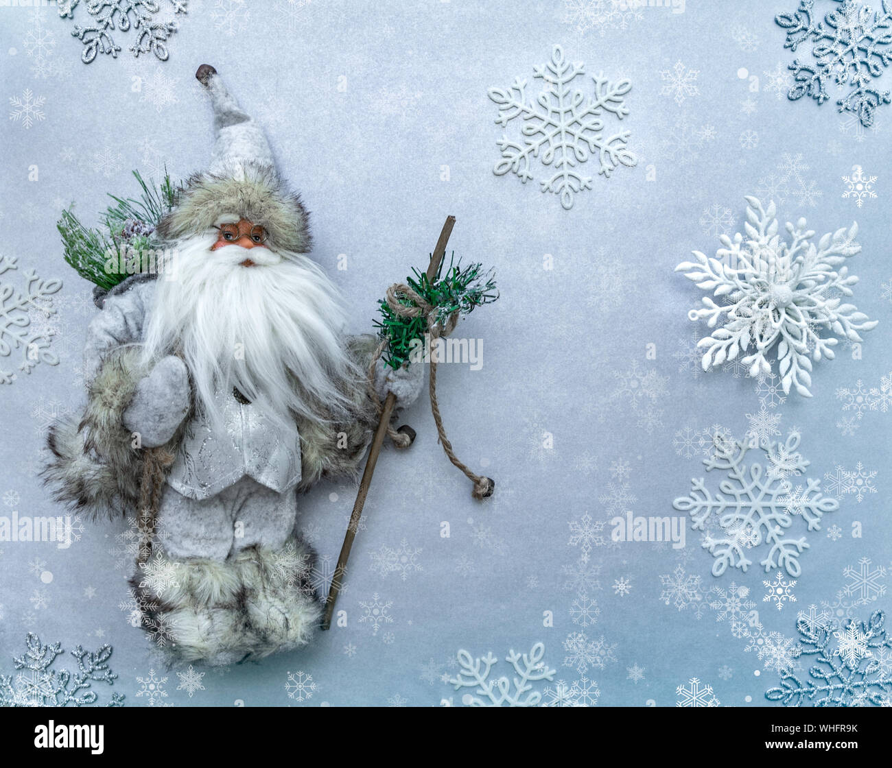 Santa figurine on silver and white Christmas background Stock Photo - Alamy