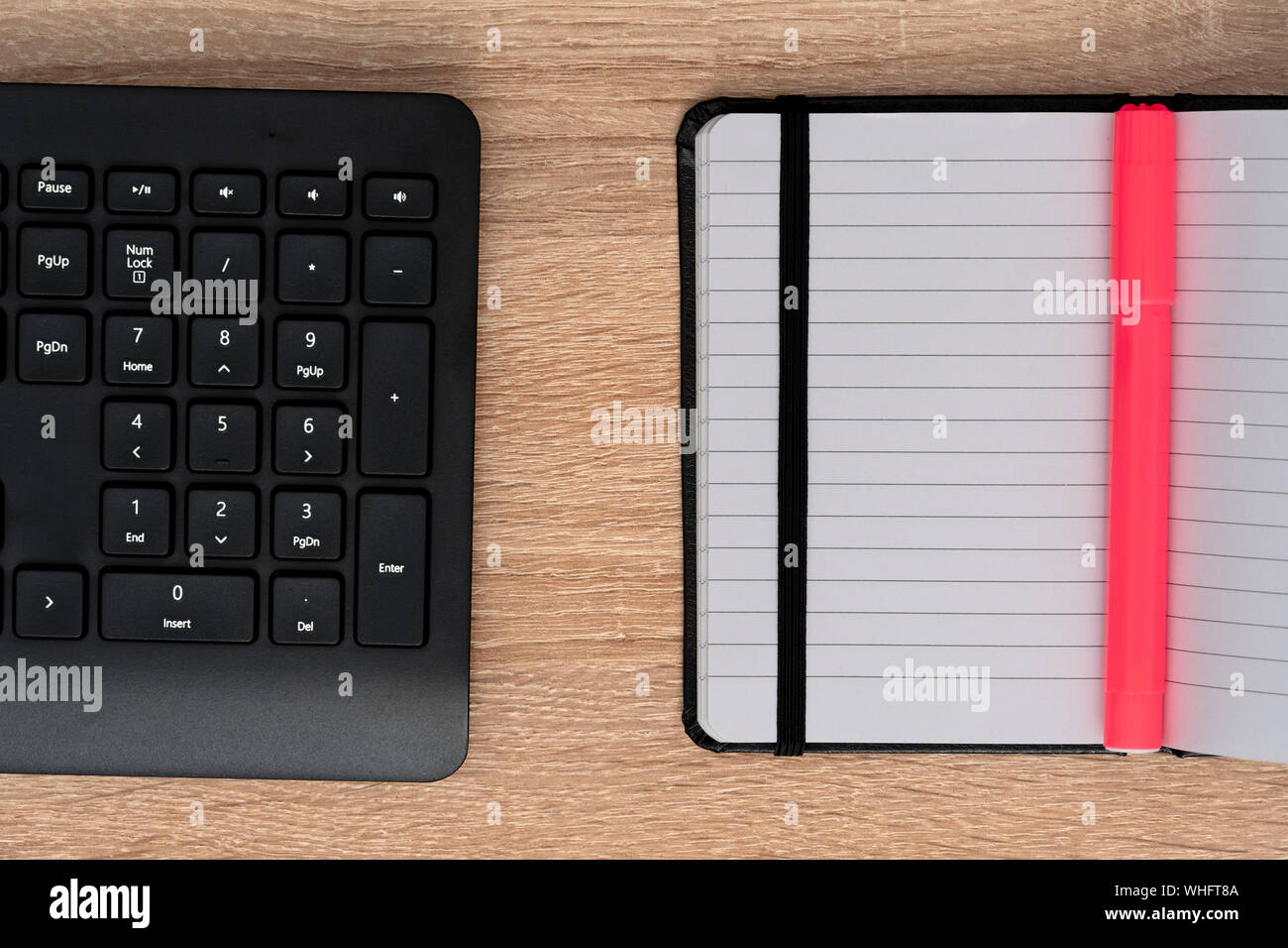 Keyboard and notebook with electric pink pen Stock Photo - Alamy