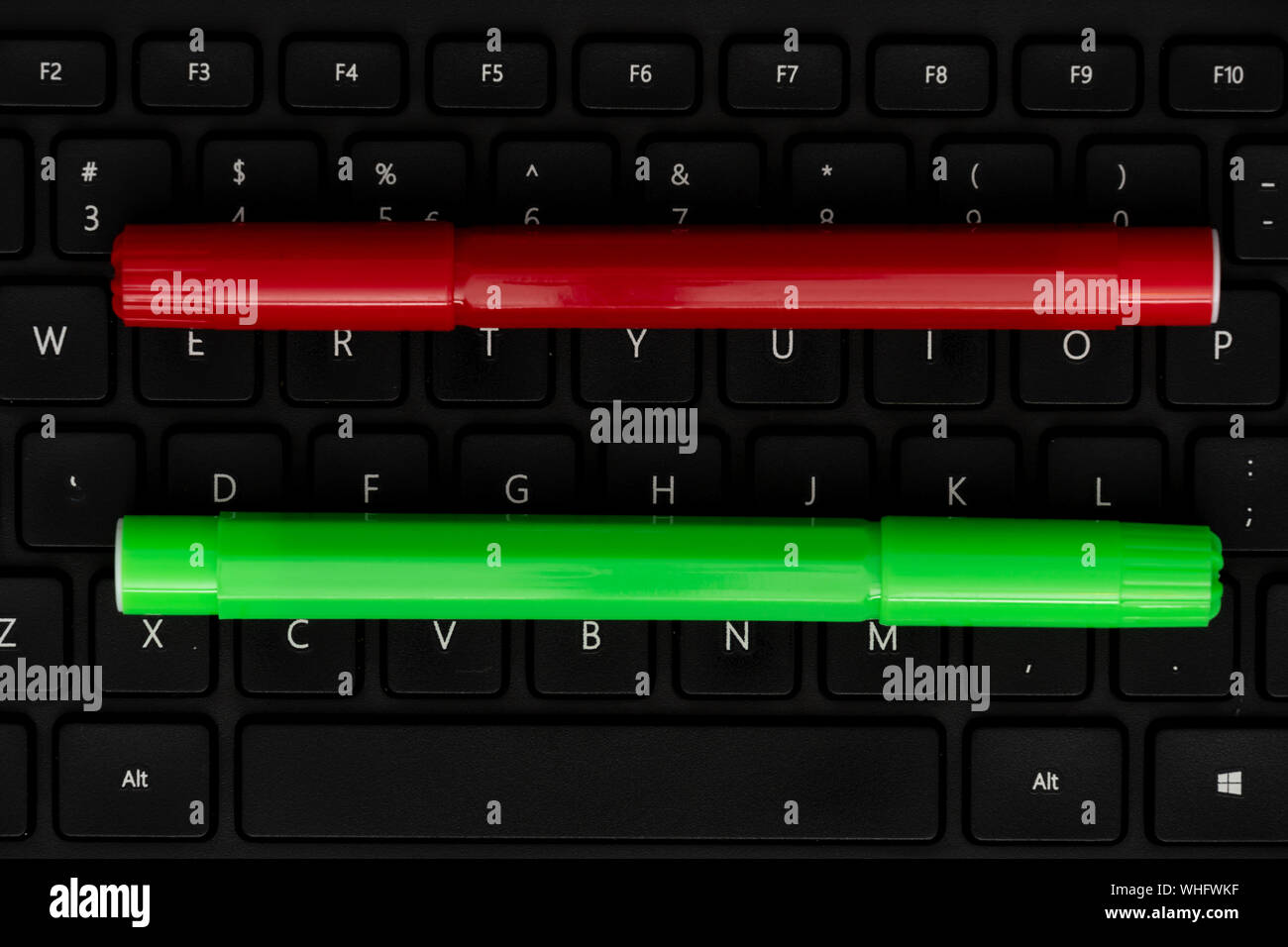 Green and pink markers on black keyboard Stock Photo - Alamy
