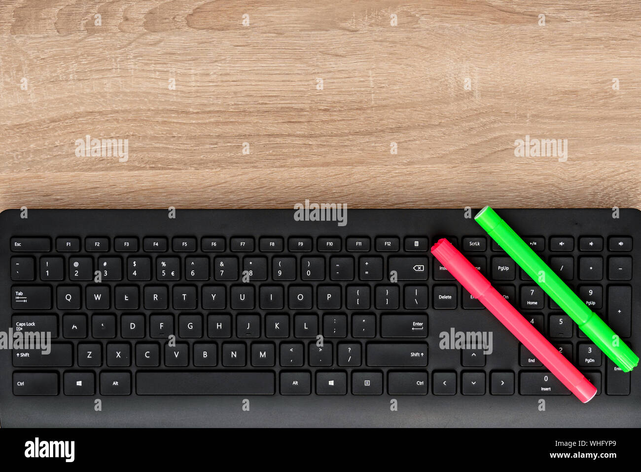 Keyboard with colored markers on wooden desk Stock Photo - Alamy