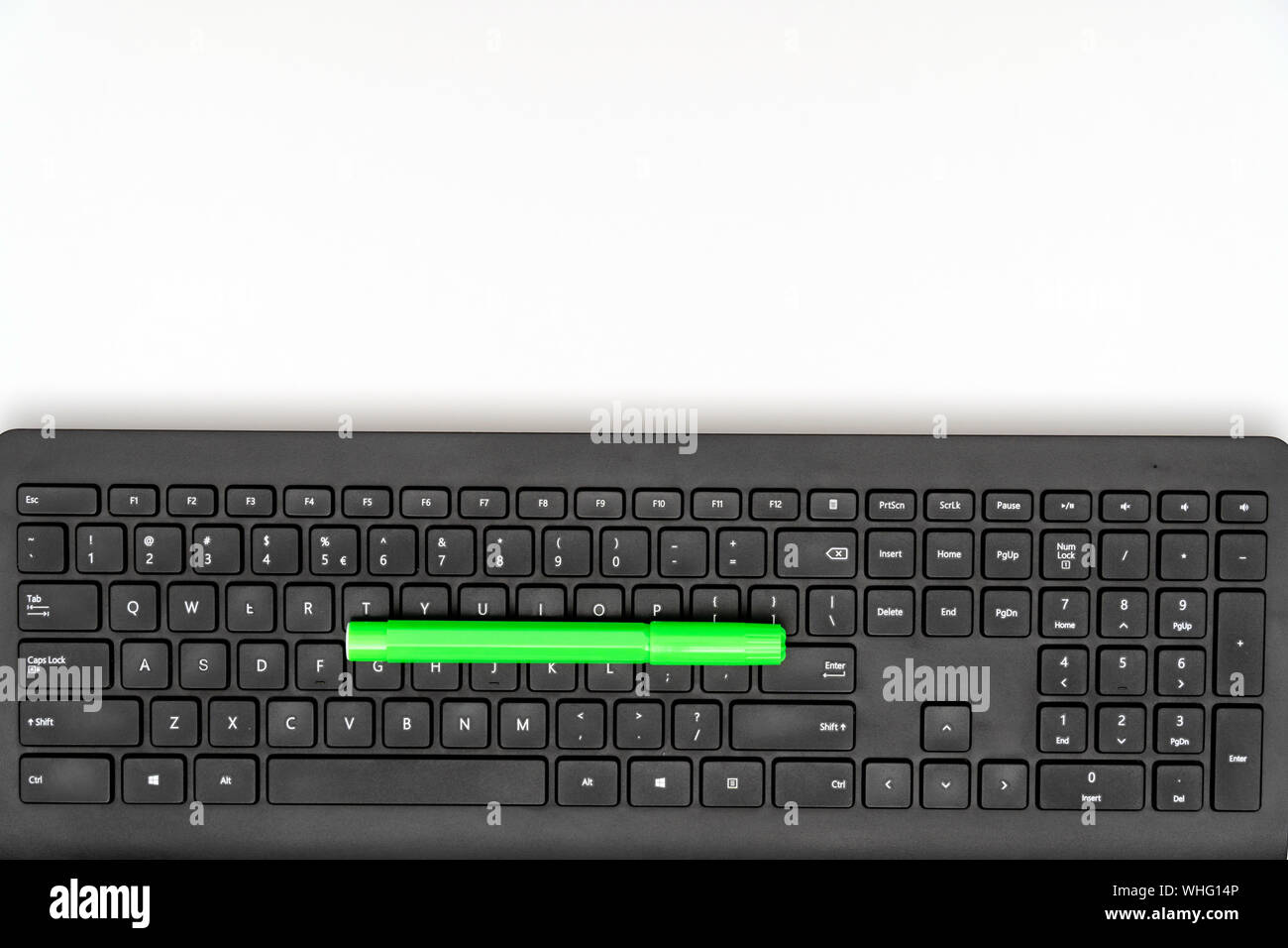 Green marker and keyboard on white background Stock Photo - Alamy