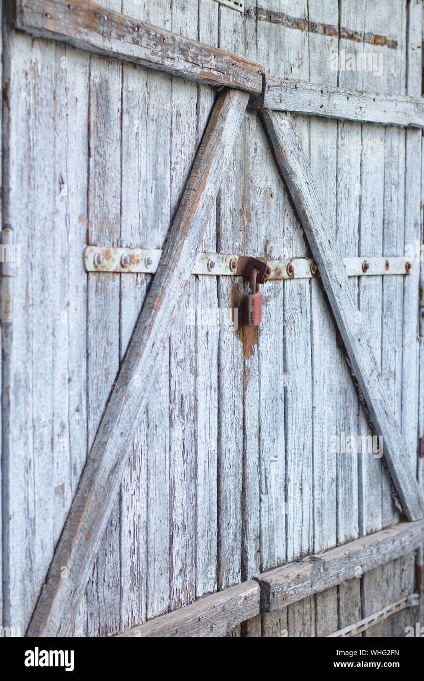 Old gray wooden plank gate with a padlock Stock Photo - Alamy
