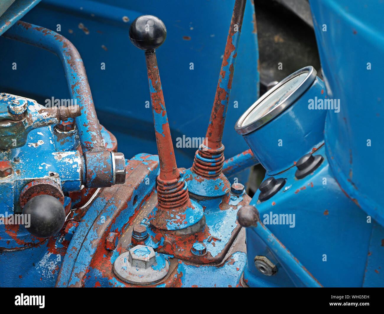 detail of old blue agricultural tractor with rusty red showing through ...