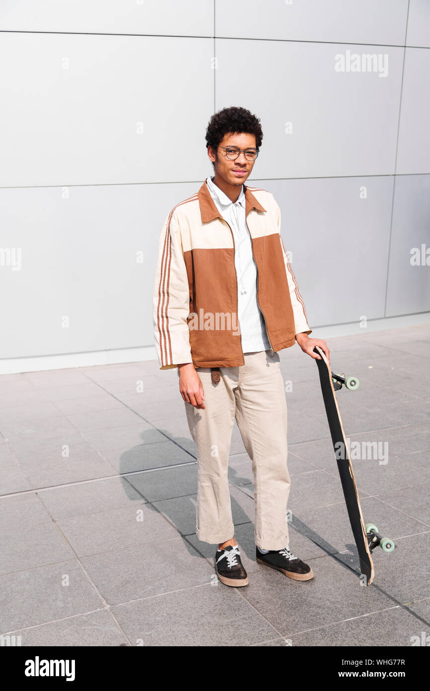 Full-length shot of afro-american young skater man Stock Photo - Alamy