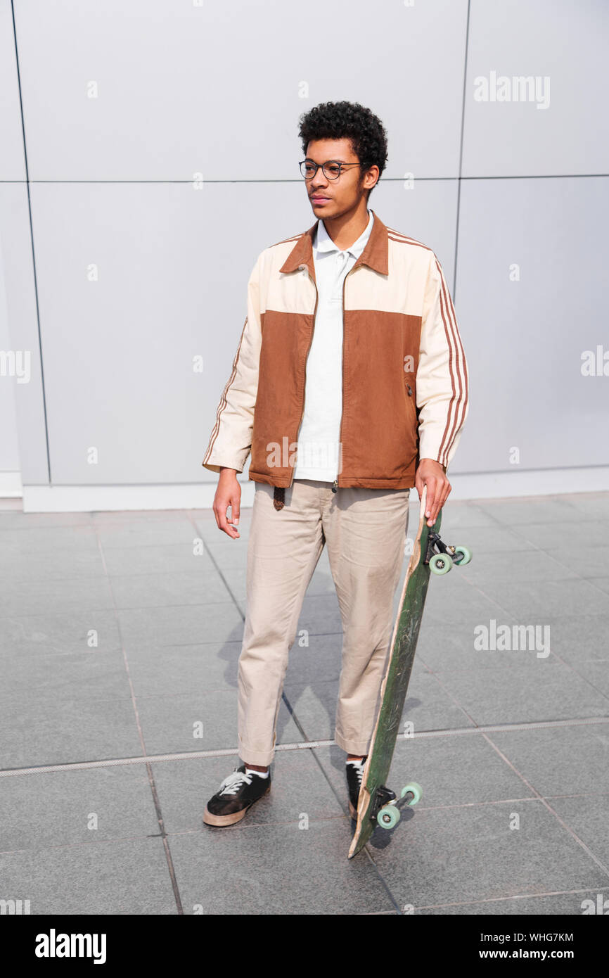 Full-length shot of afro-american young skater man Stock Photo - Alamy