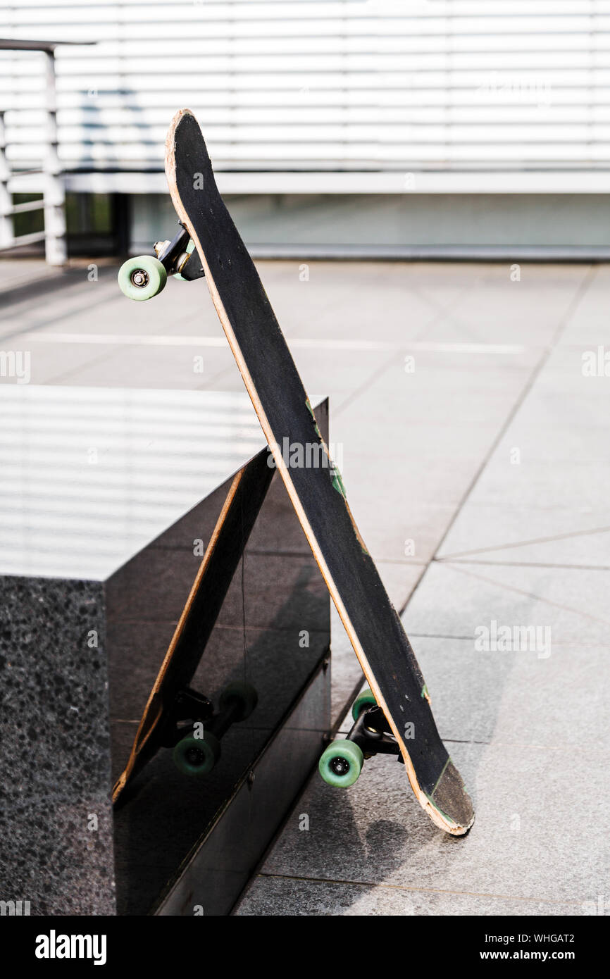 Skateboard leans against stand on white background Stock Photo - Alamy