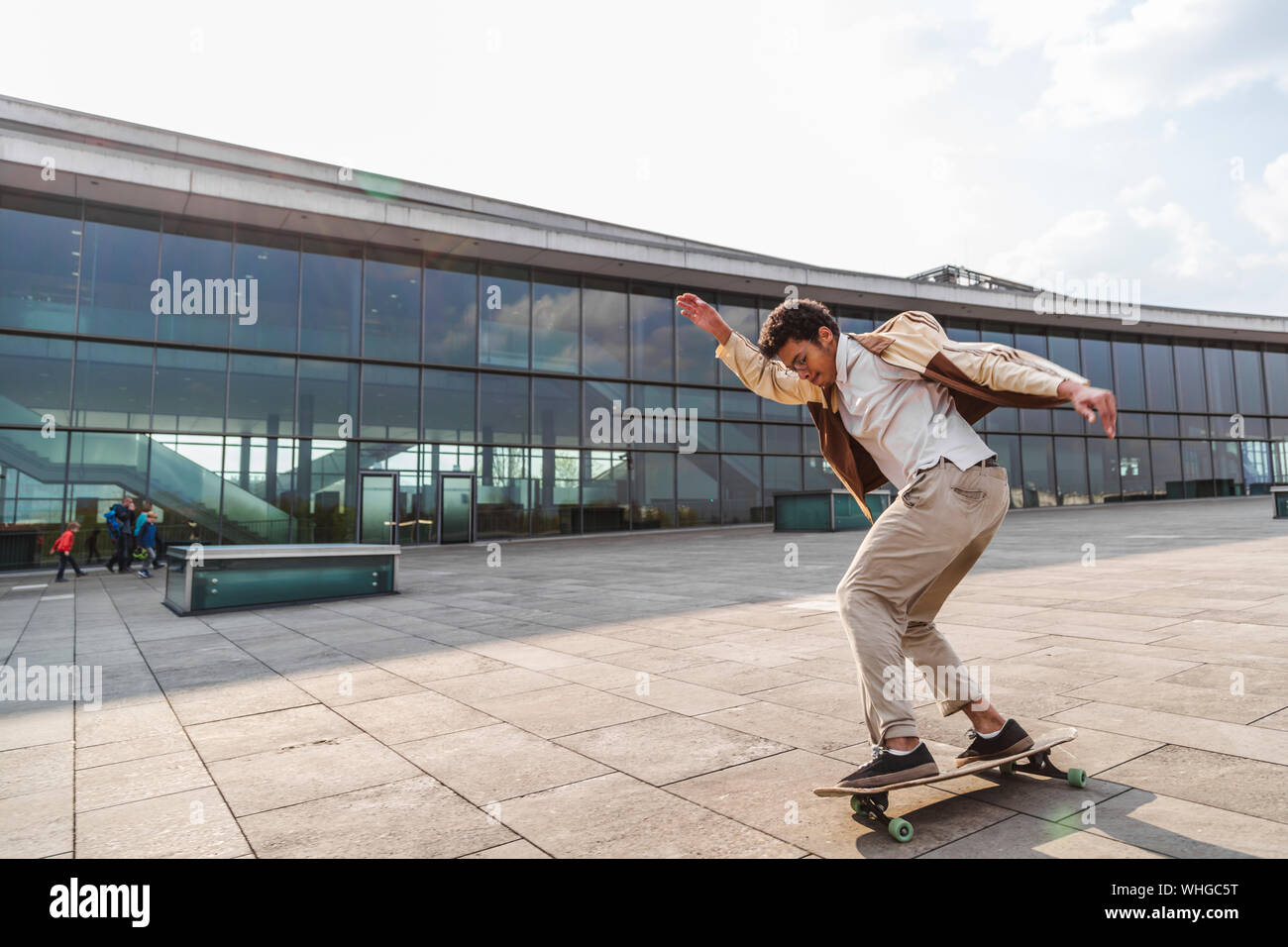 Afro guy rides and doing turn on his skateboard Stock Photo - Alamy