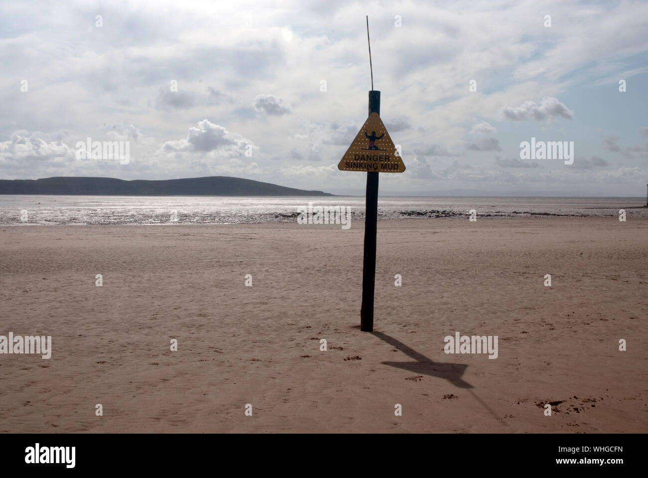 Warning sign about the danger of sinking sands on the mudflats at ...