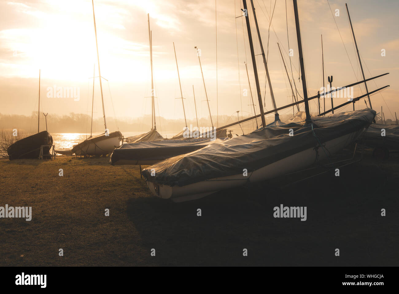Sailing boats on a lake during a frosty winter sunrise Stock Photo - Alamy