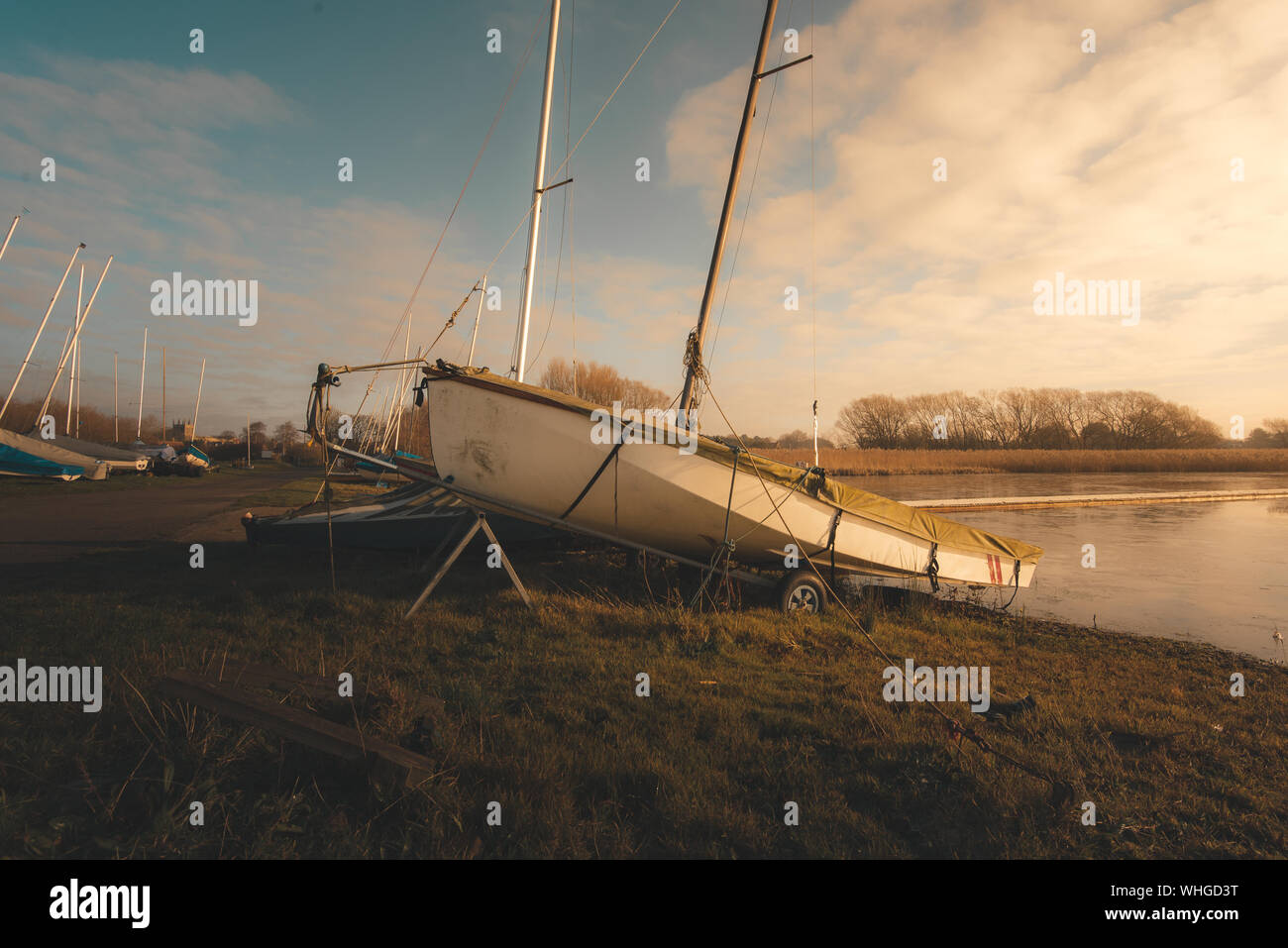 Sailing boats on a lake during a frosty winter sunrise Stock Photo - Alamy