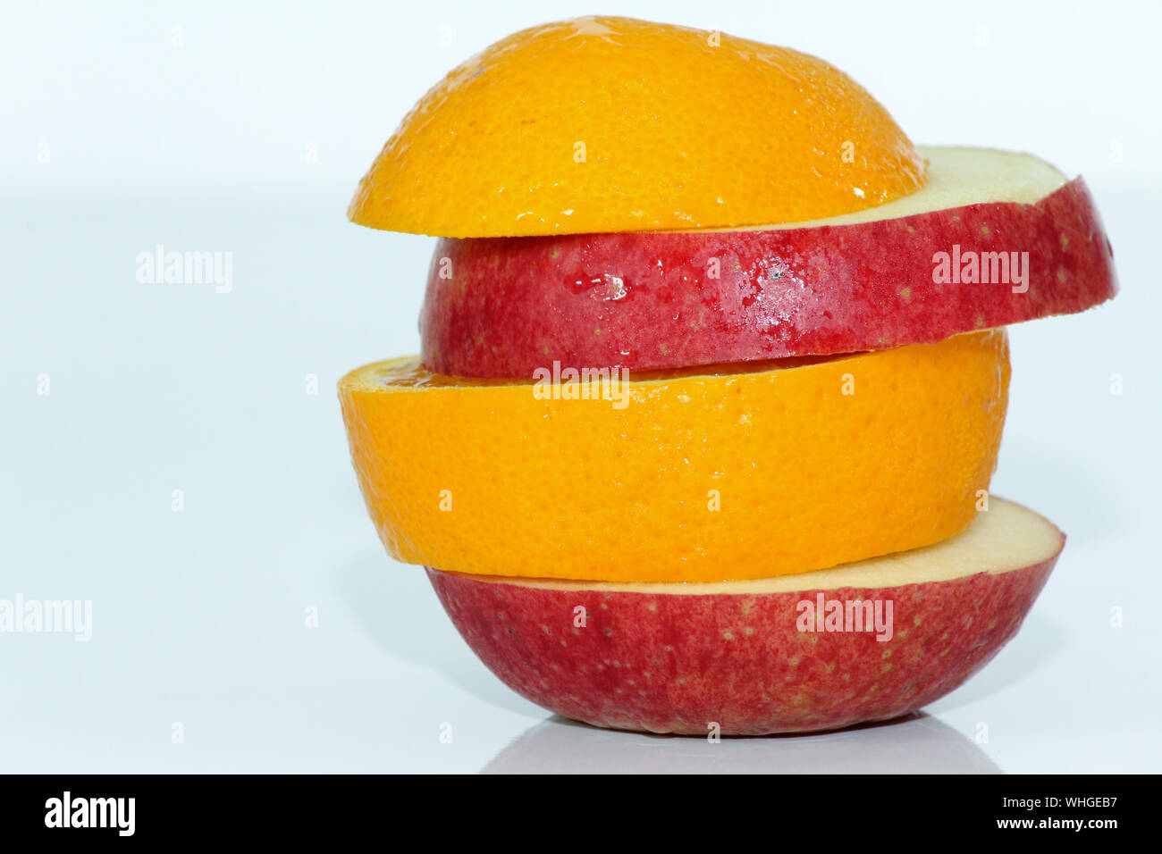Stack Of Sliced Fruits Against White Background Stock Photo - Alamy