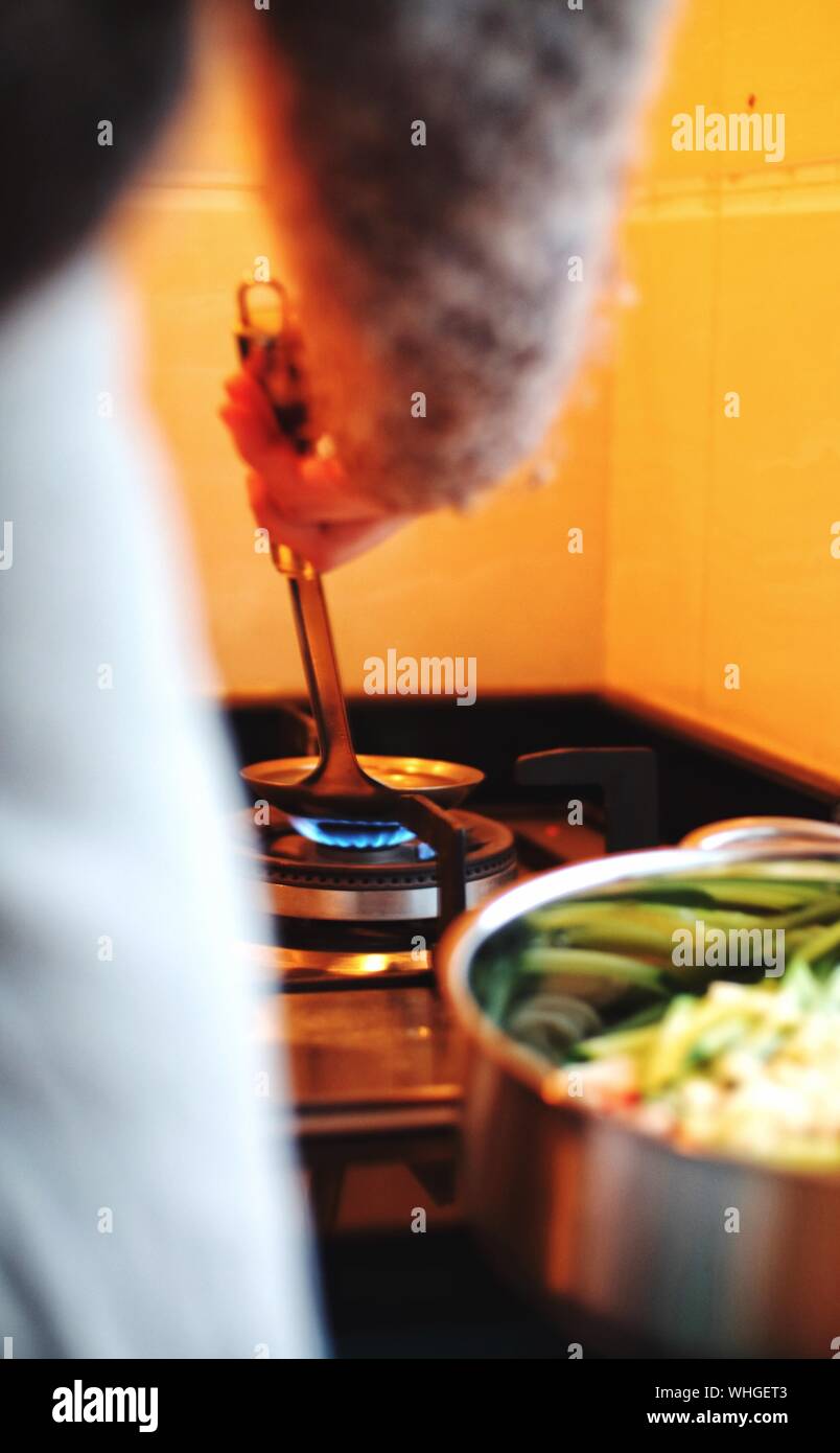 Woman cooking at stove hi-res stock photography and images - Alamy