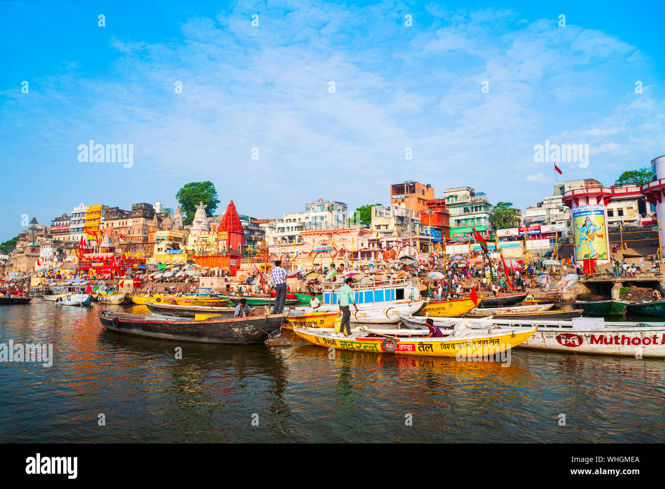 VARANASI, INDIA - APRIL 12, 2012: Colorful boats and Ganges river bank ...