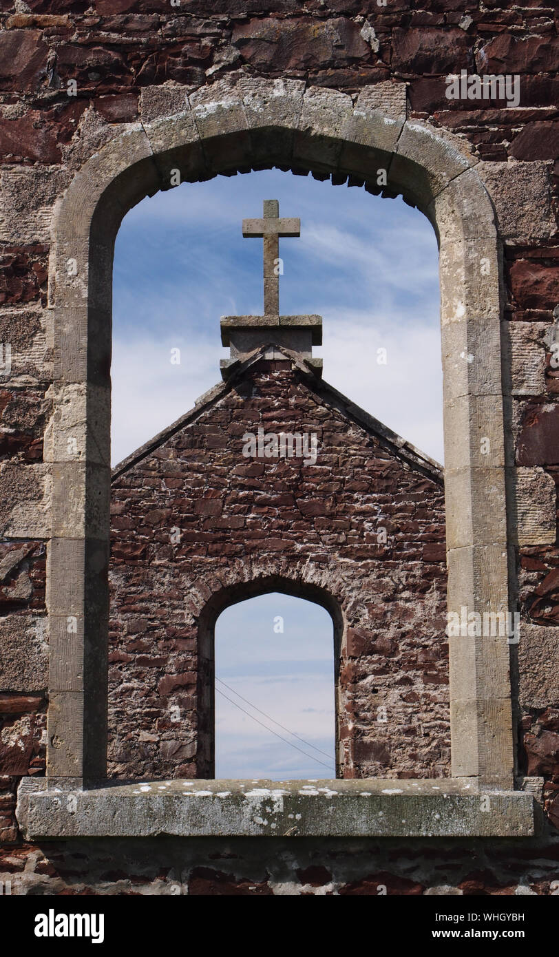 A view of a derelict church looking through a window on the gable end ...