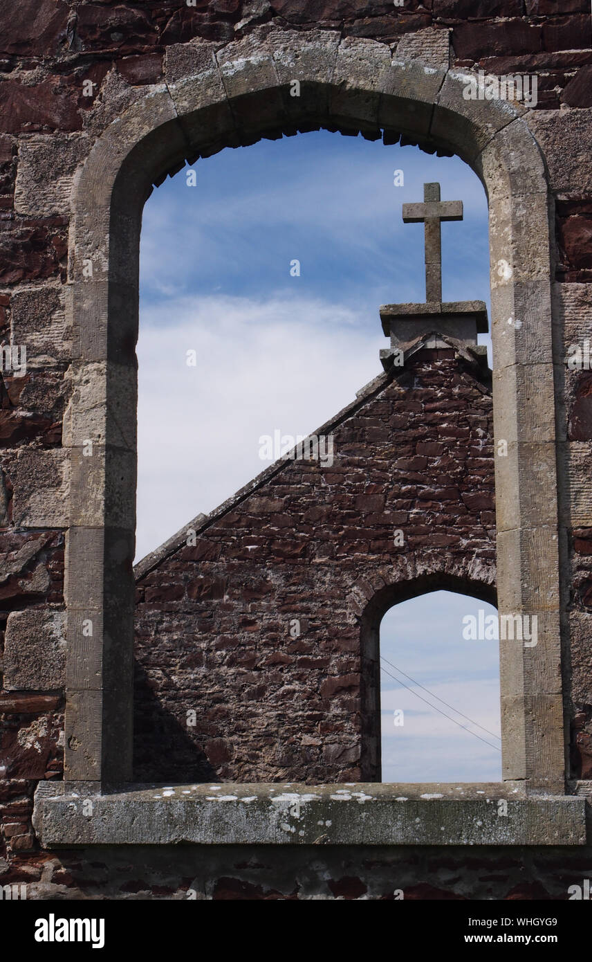 A view of a derelict church looking through a window on the gable end ...