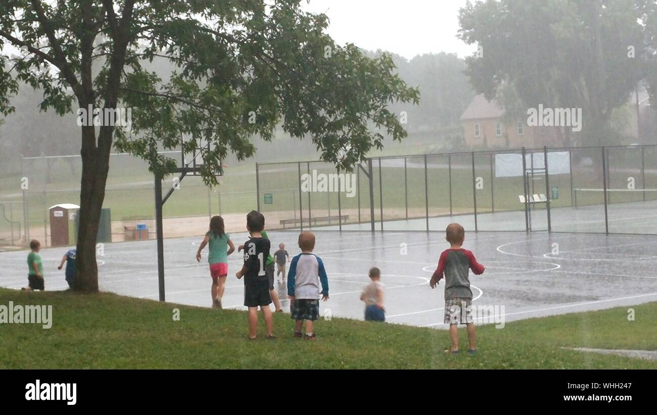 Kids Playing In Rain High Resolution Stock Photography and Images - Alamy