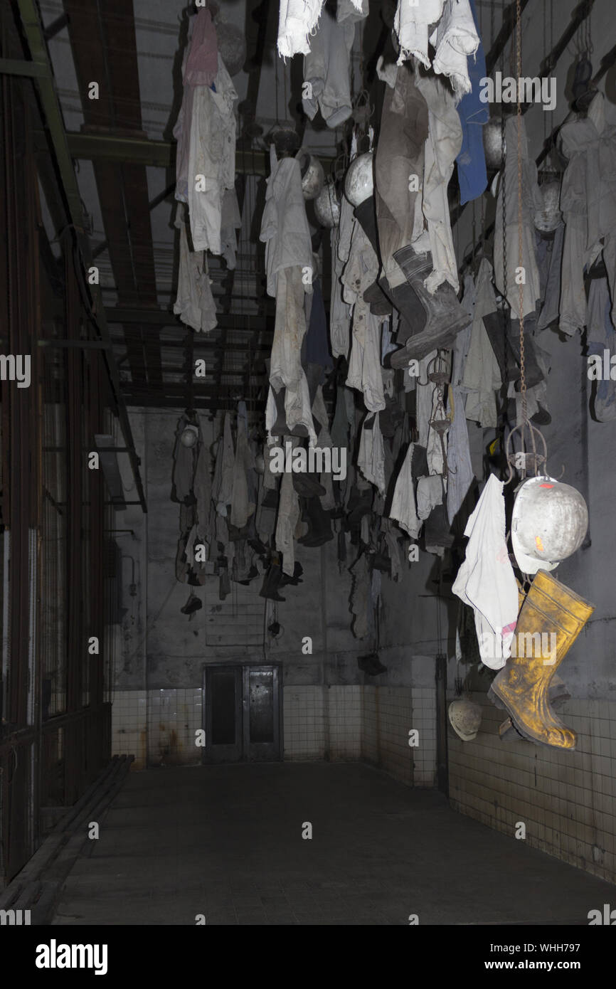 mining dressing room with mining clothes and chains Stock Photo - Alamy