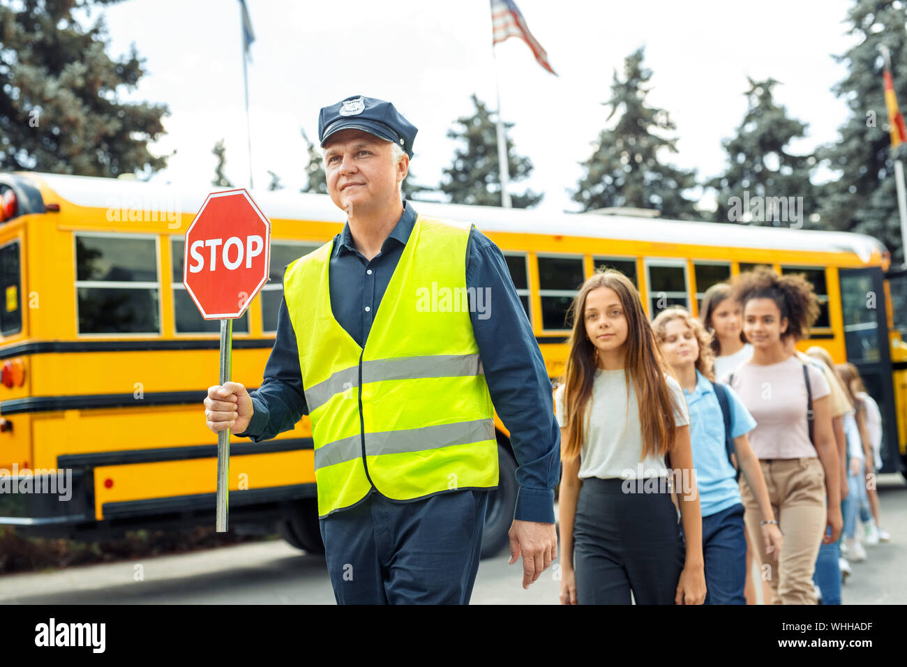 Group of children classmates going out the school bus crossing road ...