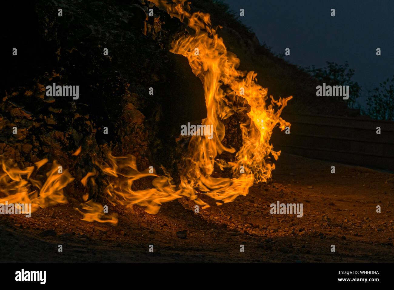 Ignited fire of natural gas at the surface of soil Stock Photo - Alamy