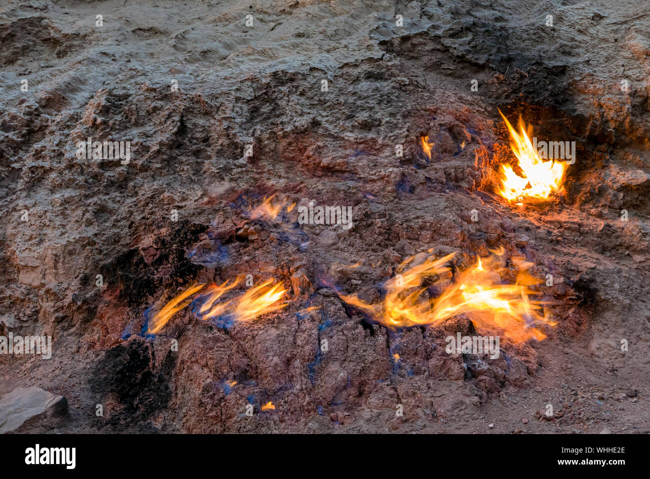 Blue and yellow gas flames, methane from the ground Stock Photo - Alamy