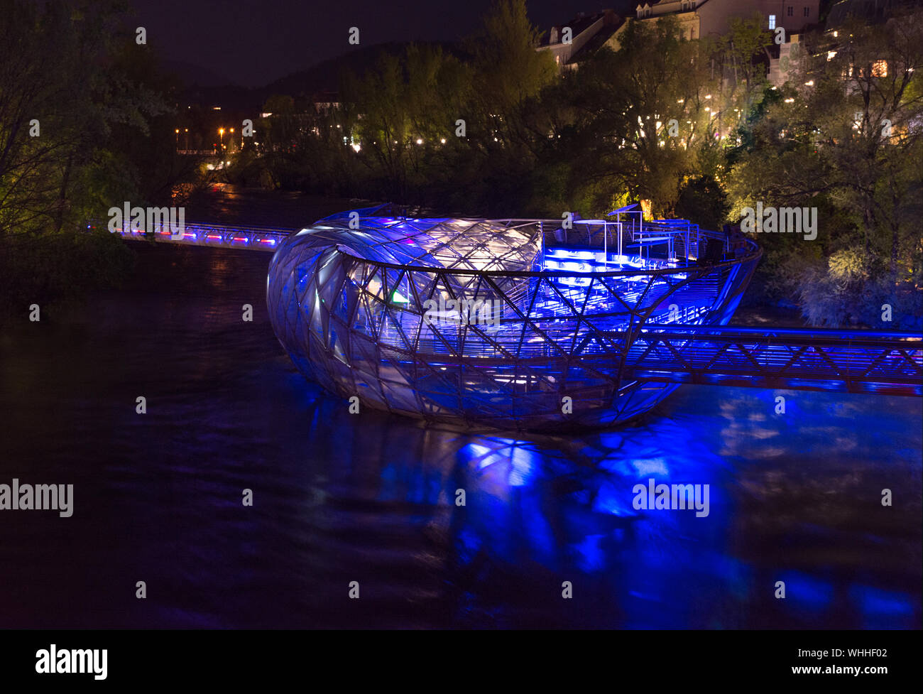 The Murinsel bridge in Mur river at night, in Graz Austria Stock Photo ...
