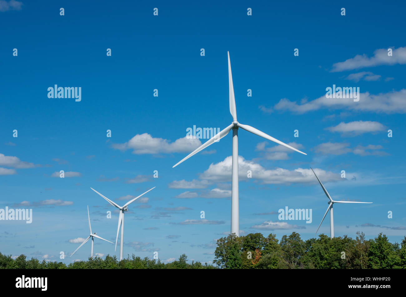 Wind turbines at a wind farm with blue sky Stock Photo - Alamy