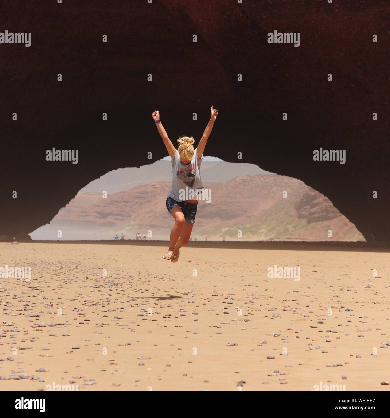 Woman jumping rock formation hi-res stock photography and images - Alamy