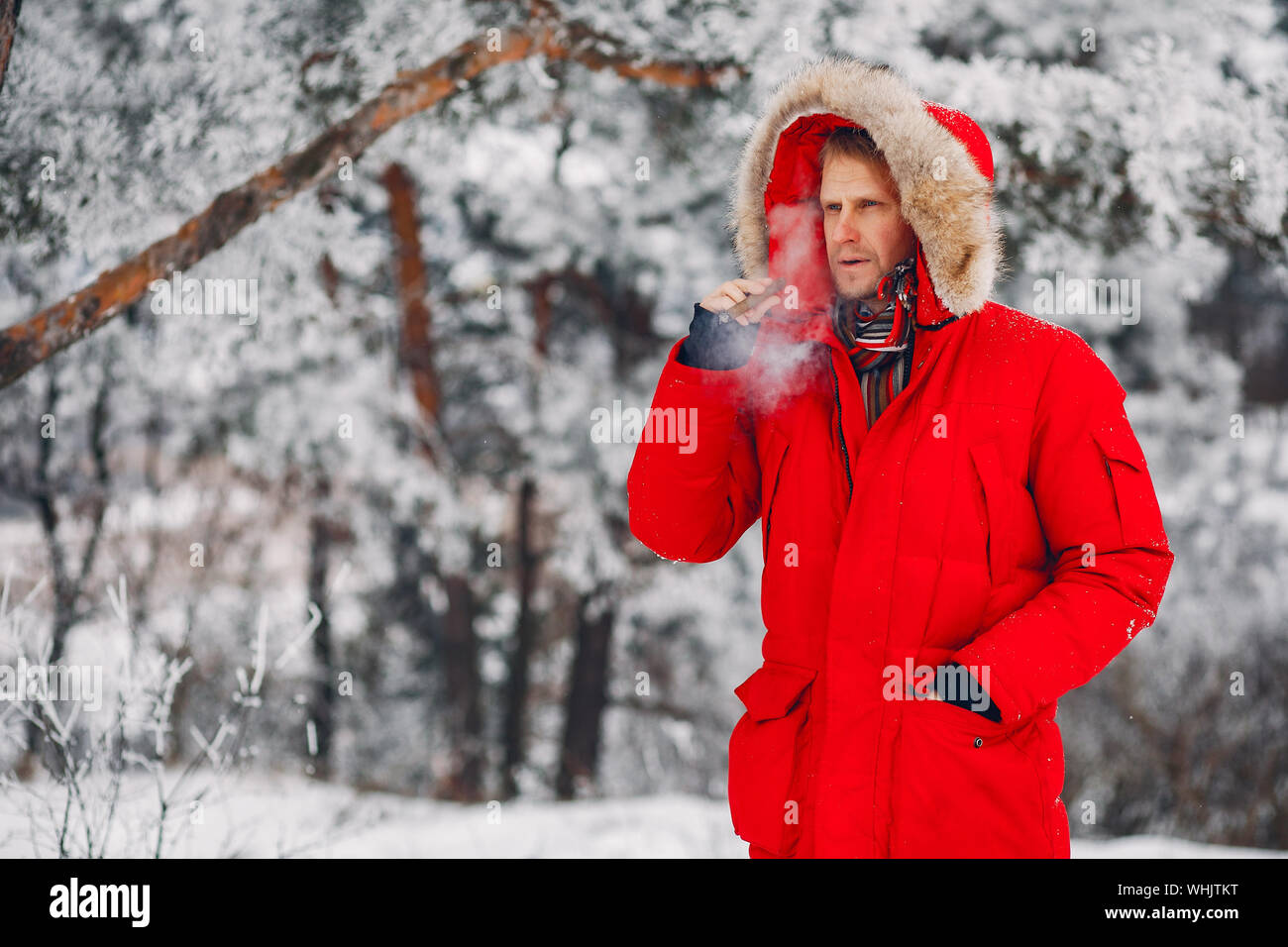 Handsome man smoke a cigar in outside Stock Photo - Alamy