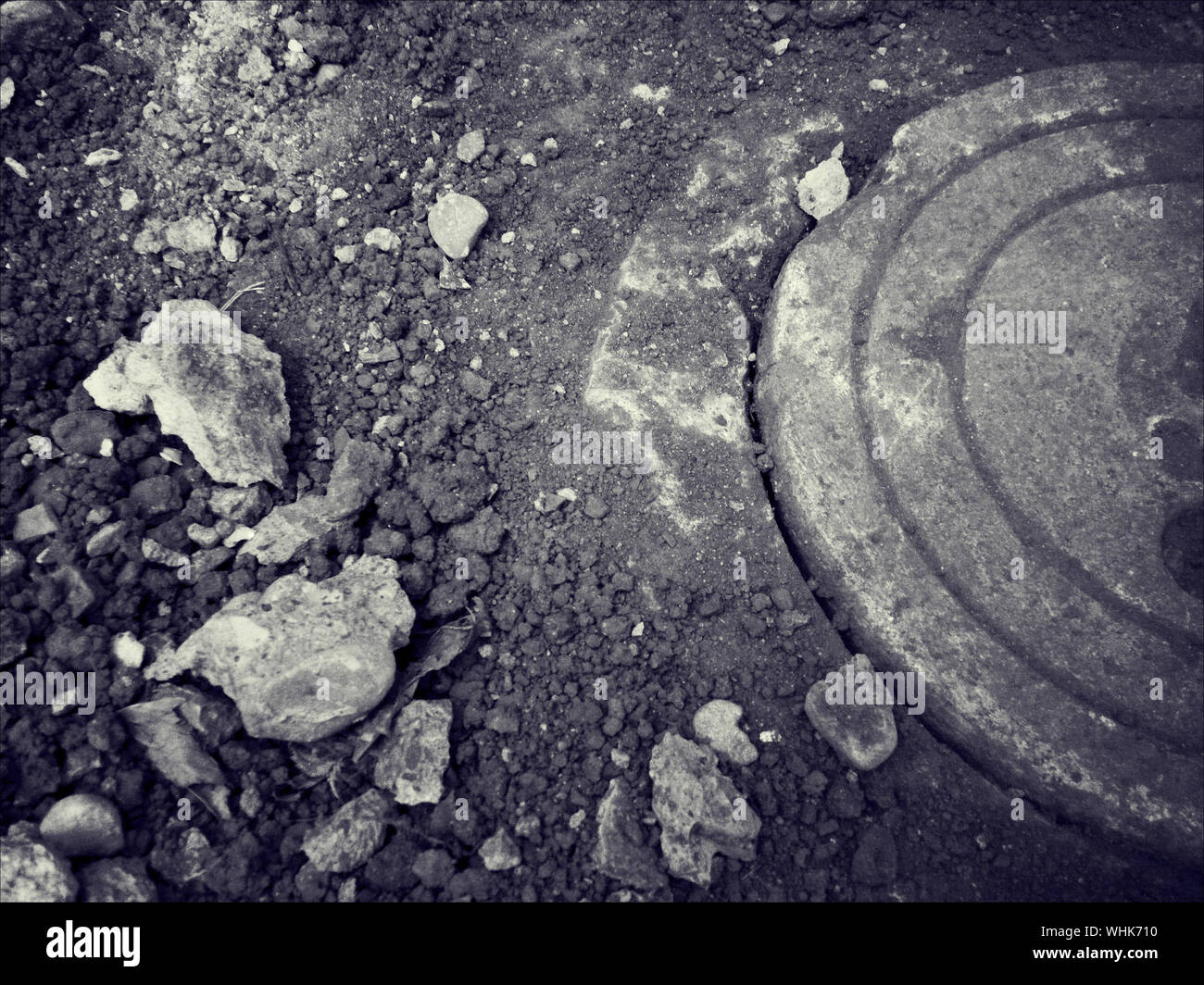 High Angle View Of Manhole Lid By Dirt Stock Photo - Alamy
