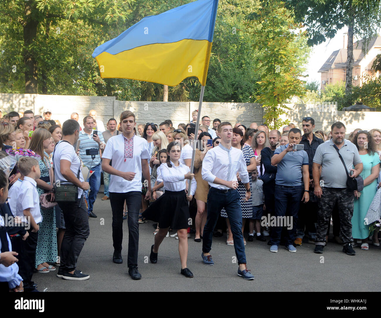 Kiev, Ukraine. 1st Sep, 2019. Pupils wave the Ukraine flag during the ...