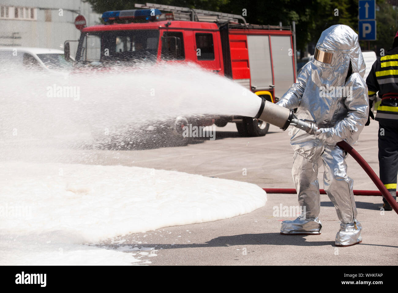 Firefighter Spraying Water Stock Photo - Alamy