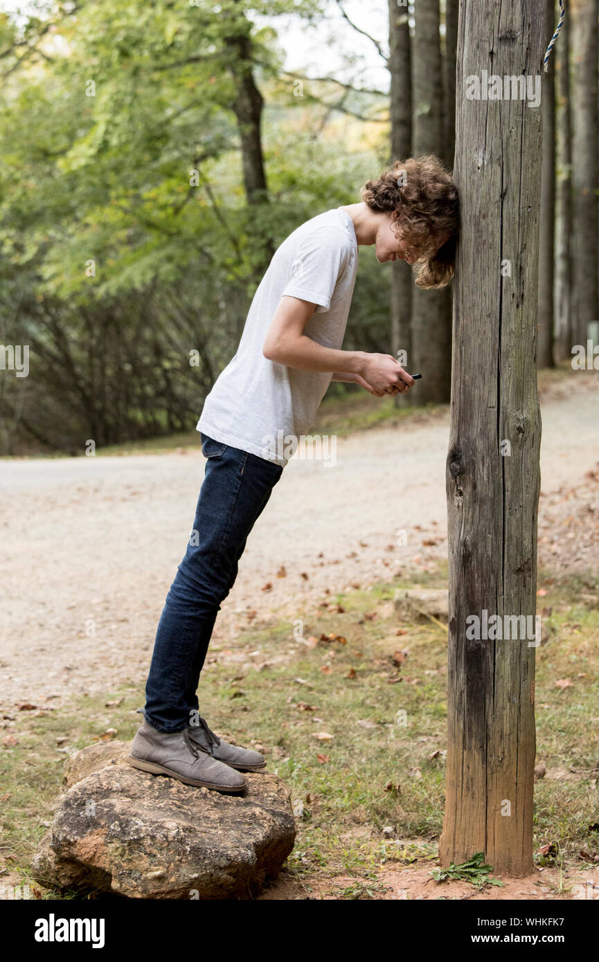 Leaning against pole hi-res stock photography and images - Alamy