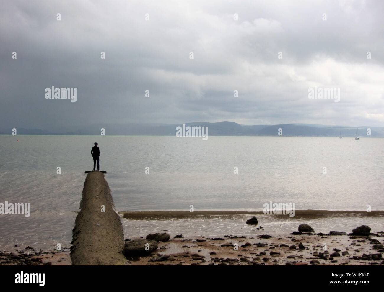 Boy standing on jetty hi-res stock photography and images - Alamy