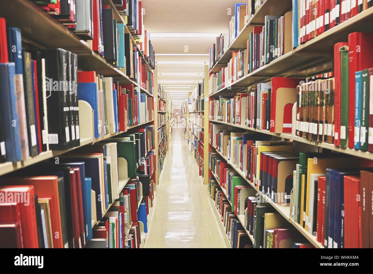 Aisle amidst bookshelves in library hi-res stock photography and images ...